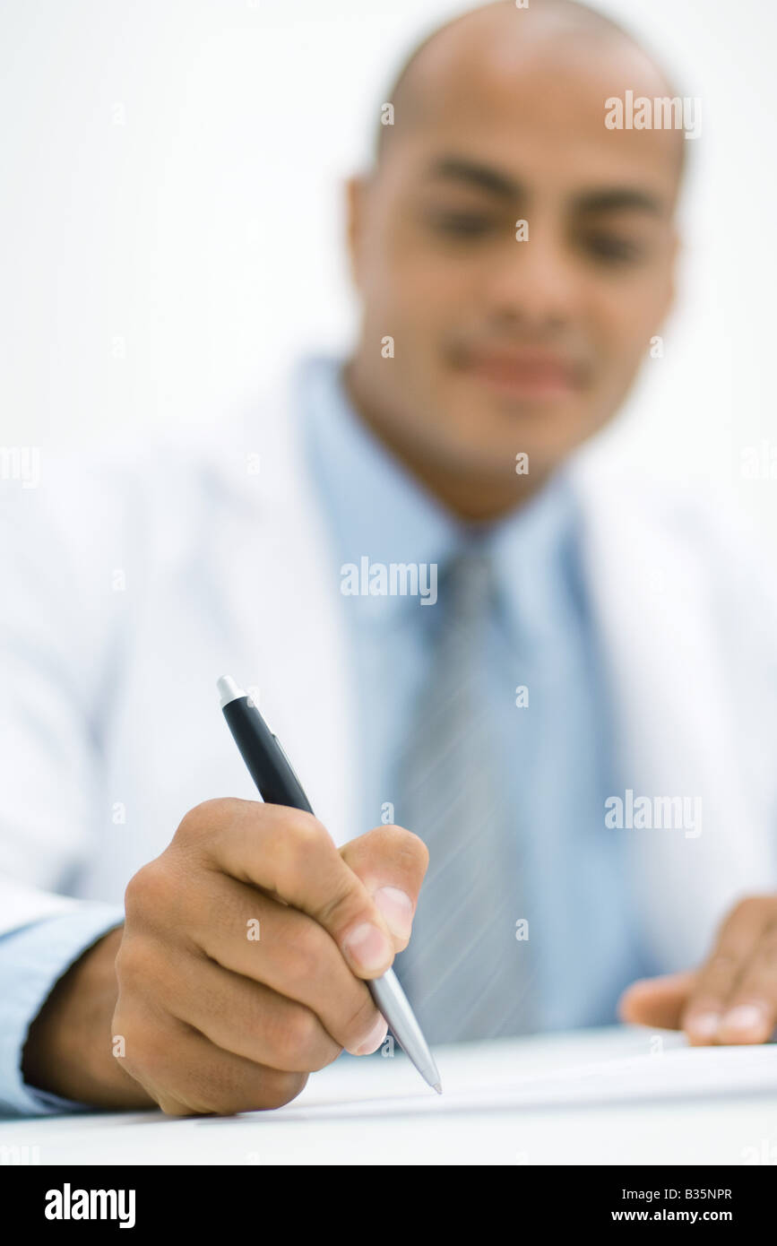 Doctor writing a prescription, focus on hand in the foreground Stock ...