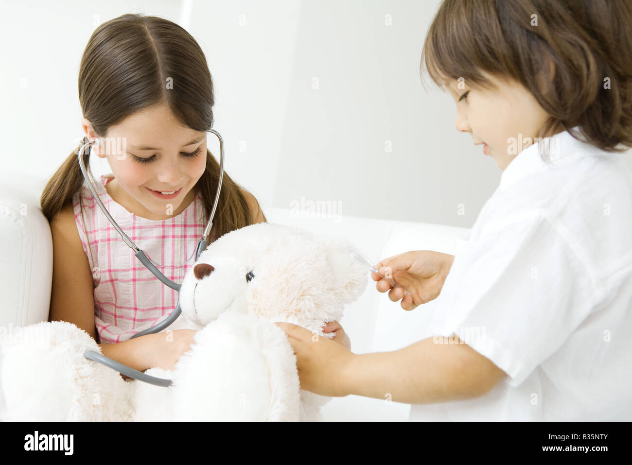 Boy girl playing doctor teddy hi-res stock photography and images - Alamy