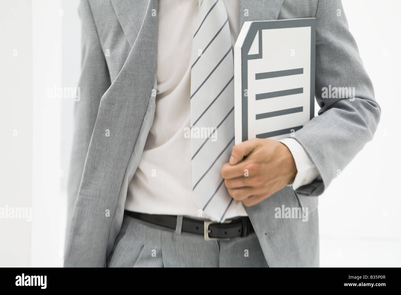 Businessman carrying document, cropped view of mid section Stock Photo ...