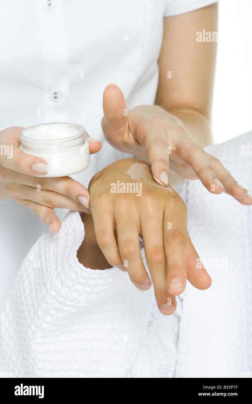 Woman applying cream to another woman's hand, cropped view Stock Photo ...
