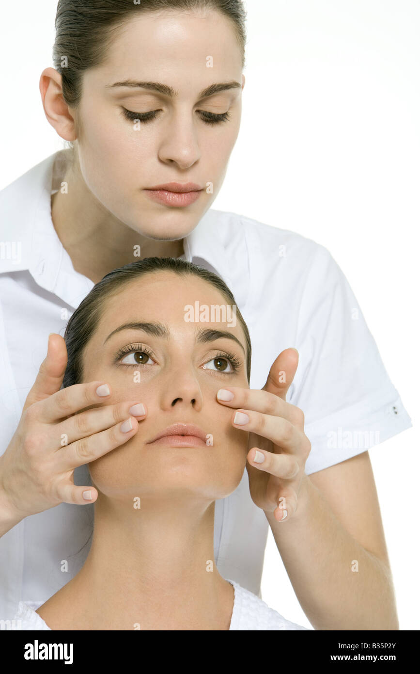 Woman receiving facial massage, looking up and away Stock Photo - Alamy