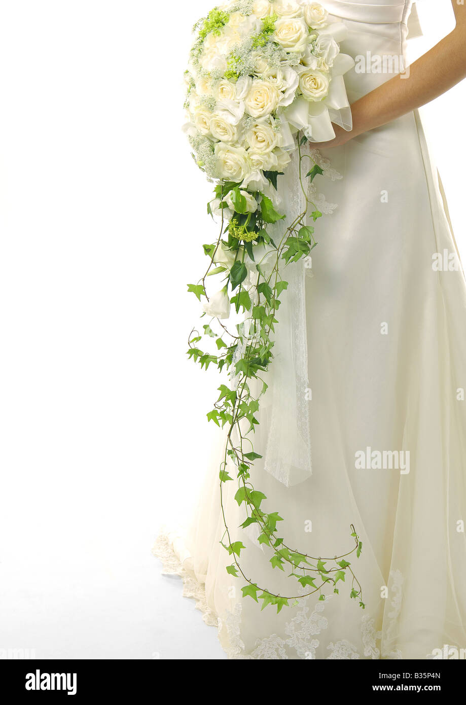 Mid section view of a bride holding a bouquet of flowers Stock Photo ...