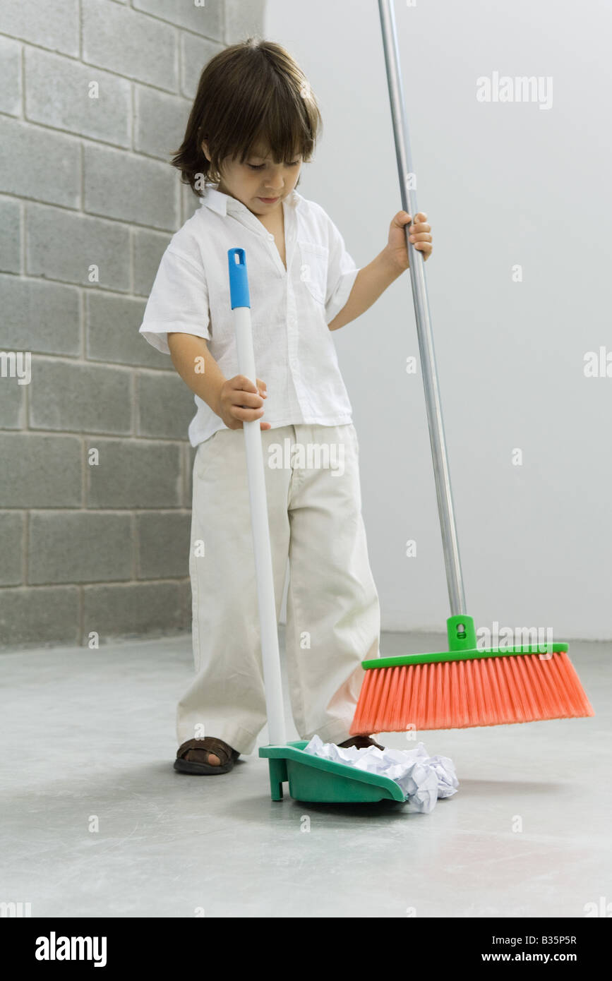 Little boy sweeping the floor Stock Photo - Alamy