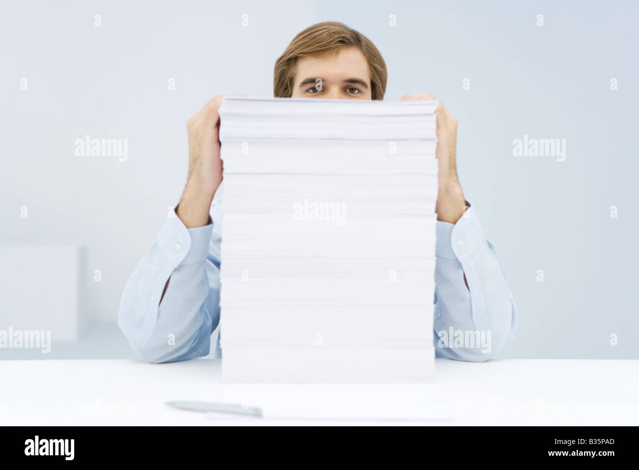 Man behind stack papers hi-res stock photography and images - Alamy