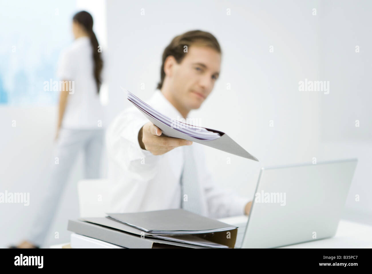 Handing folder hi-res stock photography and images - Alamy