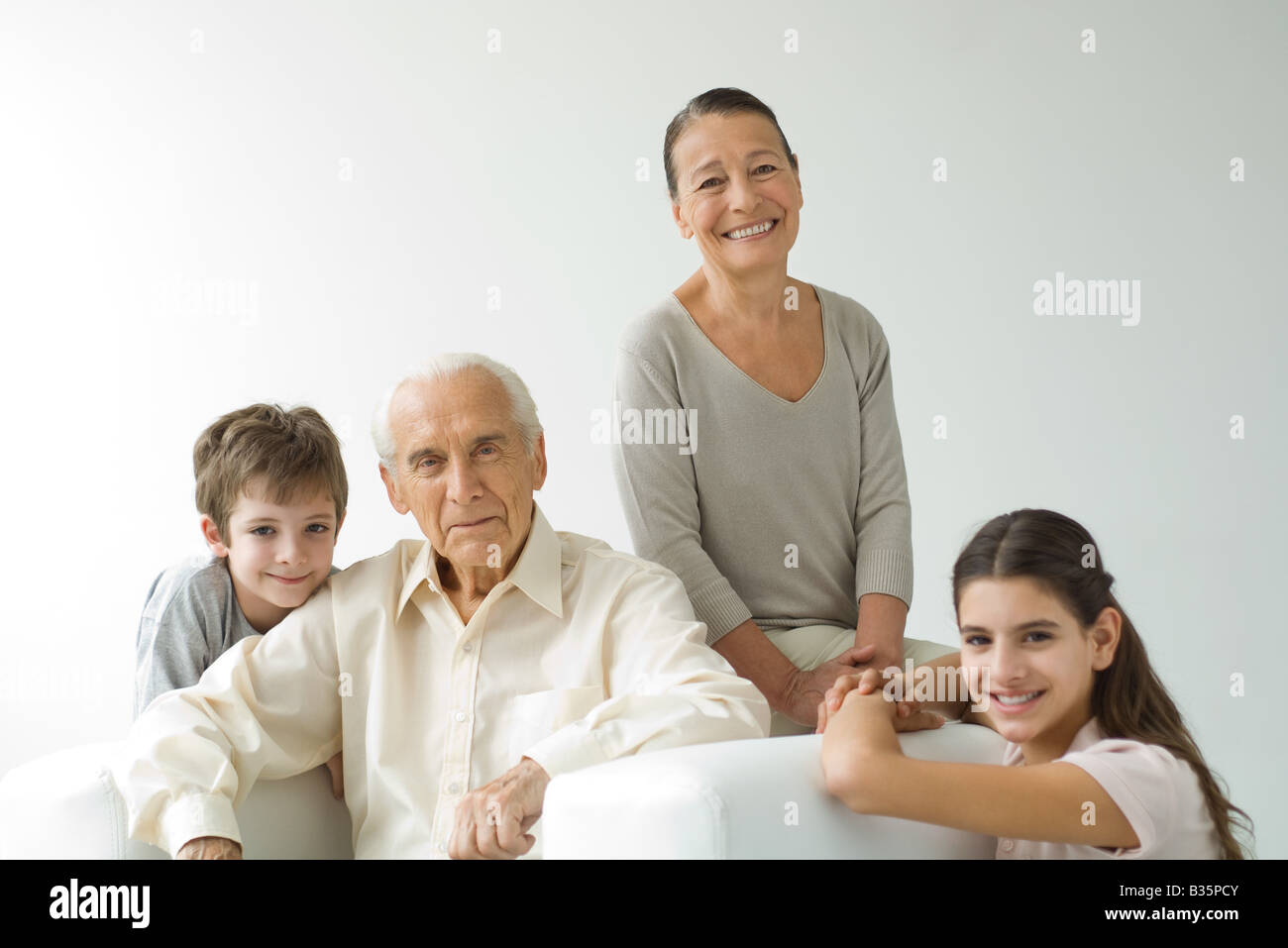 Grandparents sitting with grandchildren, all smiling, portrait Stock ...