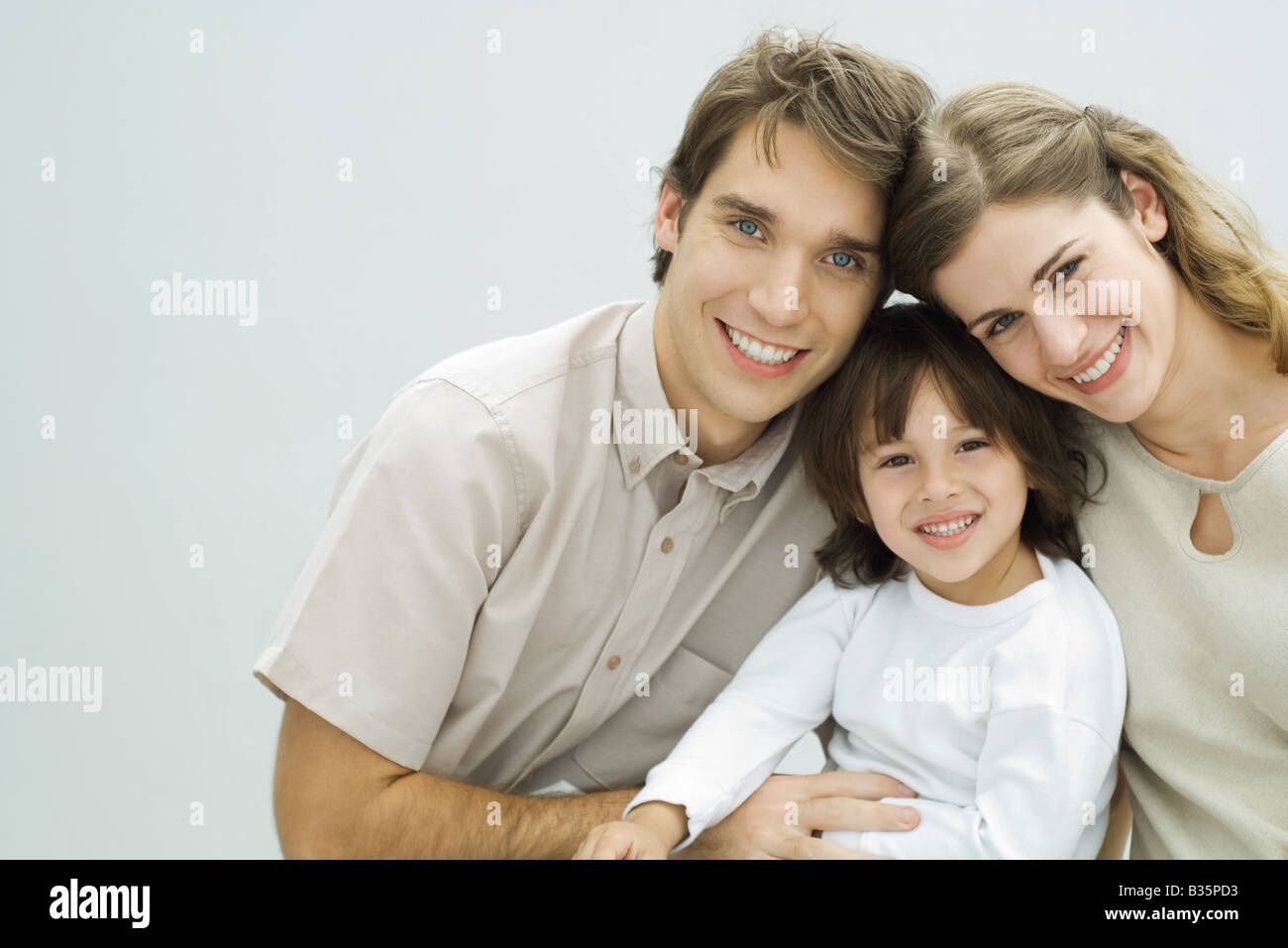 Young parents with little boy, smiling at camera, portrait Stock Photo ...