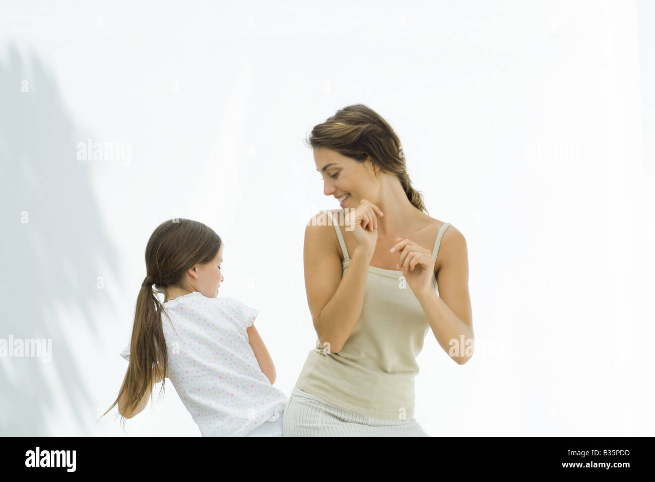 Mother dancing with daughter, bumping hips together Stock Photo - Alamy