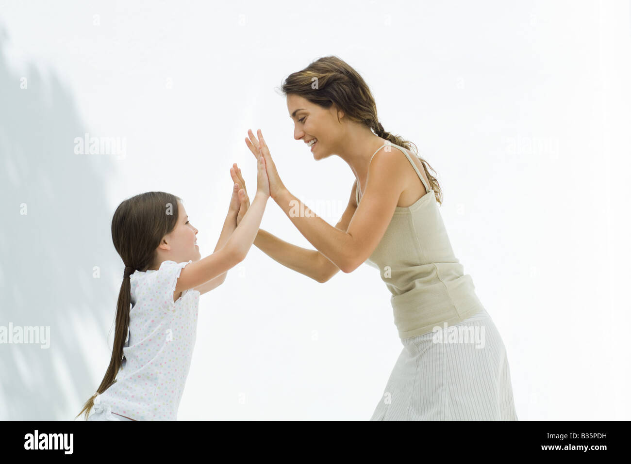 Mother and daughter playing clapping game together Stock Photo - Alamy