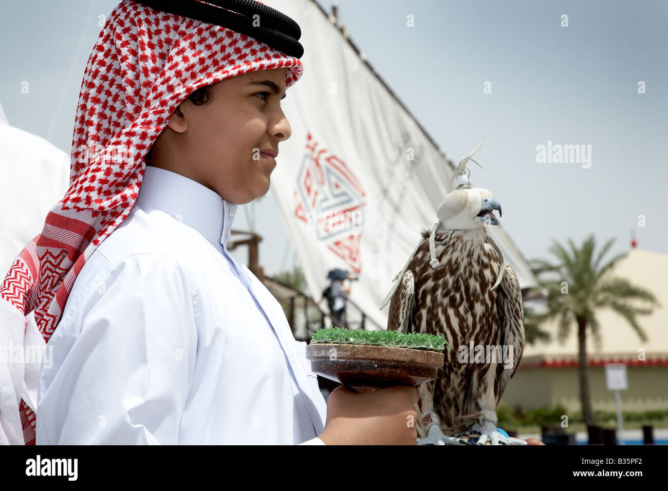 Bahrainian boy holding bird of prey at the 2008 Bahrain Formula 1 Grand ...