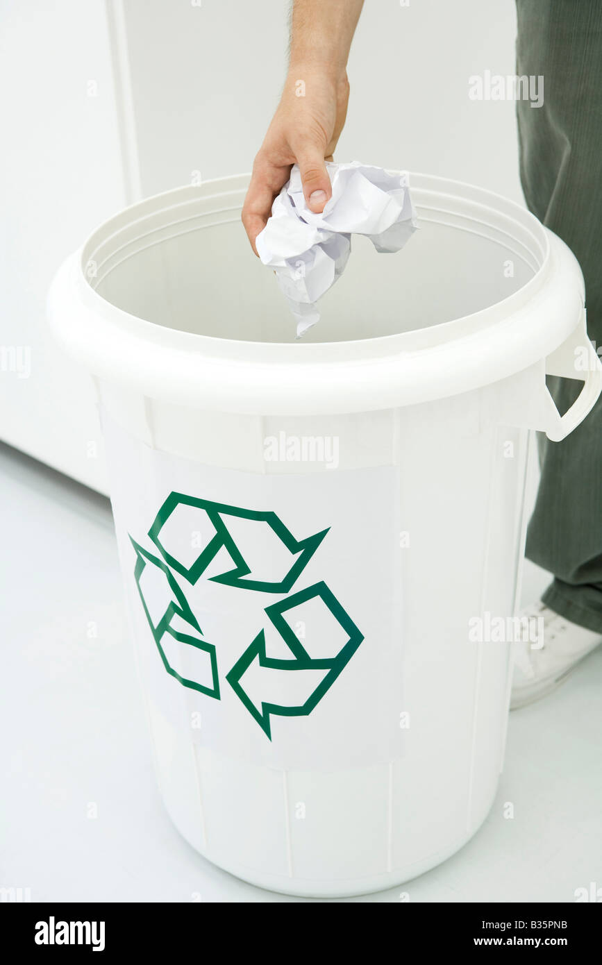 Man throwing crumpled paper in recycling bin, cropped view Stock Photo ...