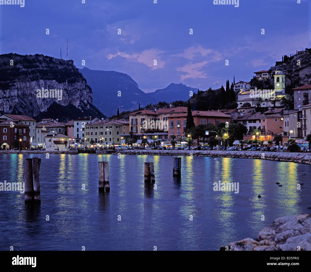 Torbole waterfront illuminated at dusk, Lake Garda, Italy Stock Photo ...