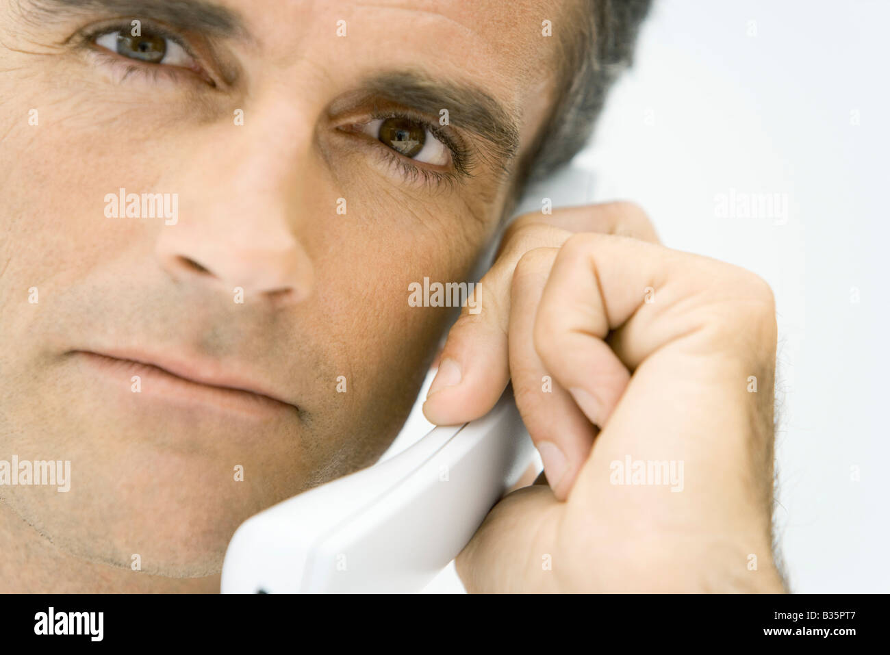 Man using phone, looking at camera, close-up Stock Photo - Alamy