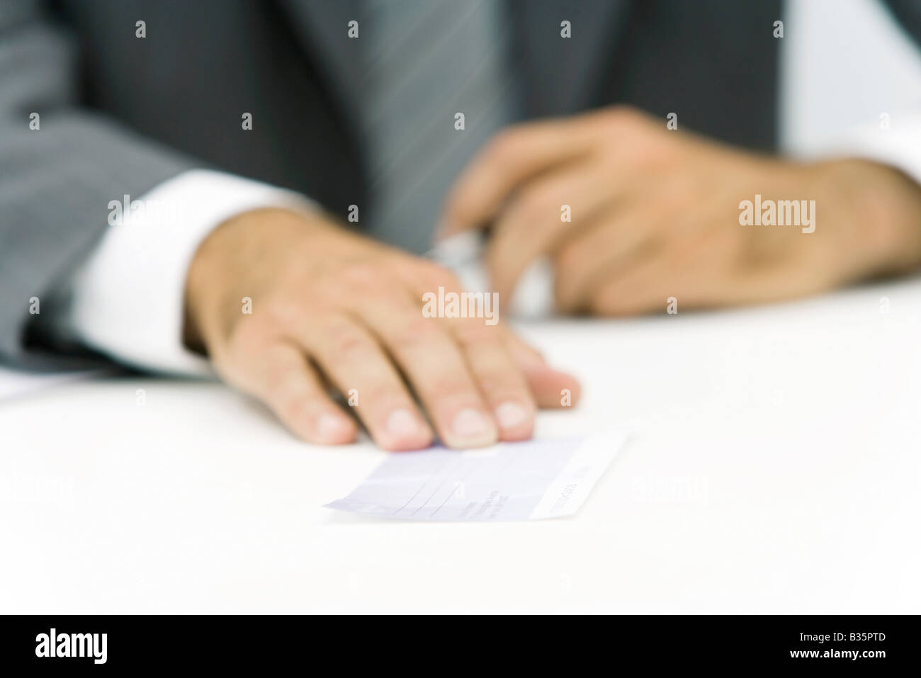 Businessman holding check, low angle view, cropped Stock Photo - Alamy