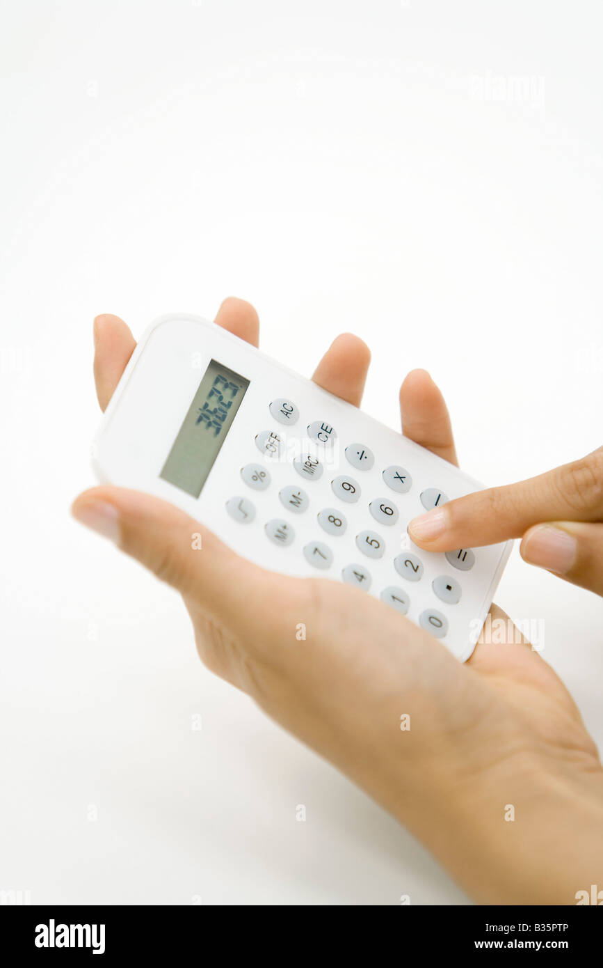 Person using calculator, cropped view of hands Stock Photo - Alamy
