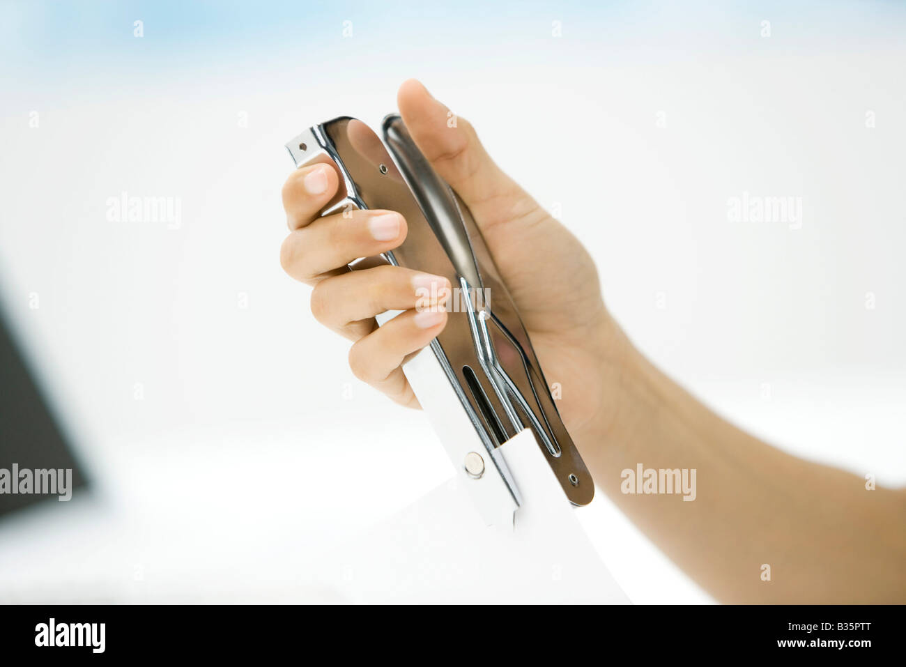 Person stapling document, cropped view of hand Stock Photo - Alamy