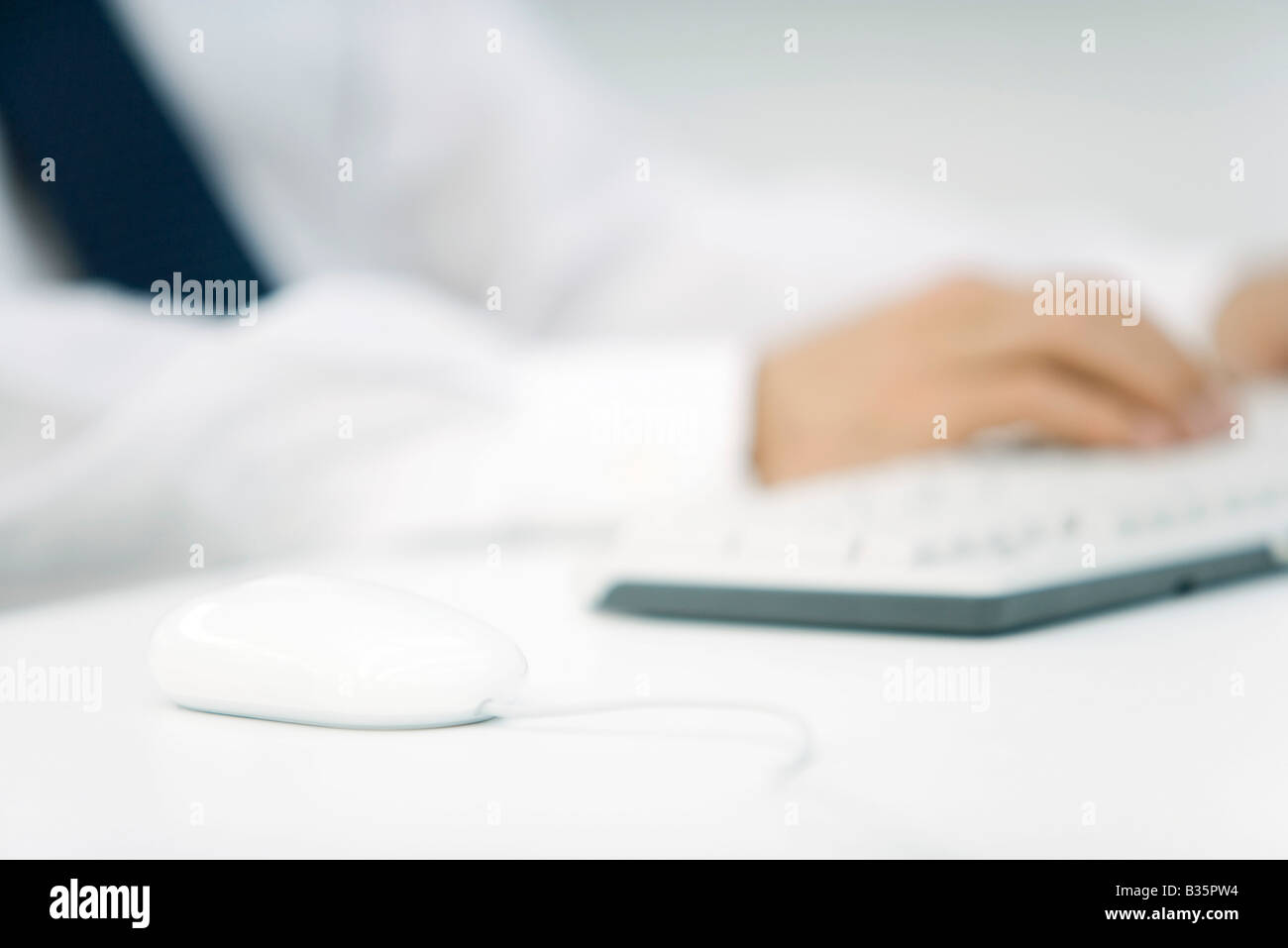Man typing, focus on computer mouse in foreground, cropped view Stock ...