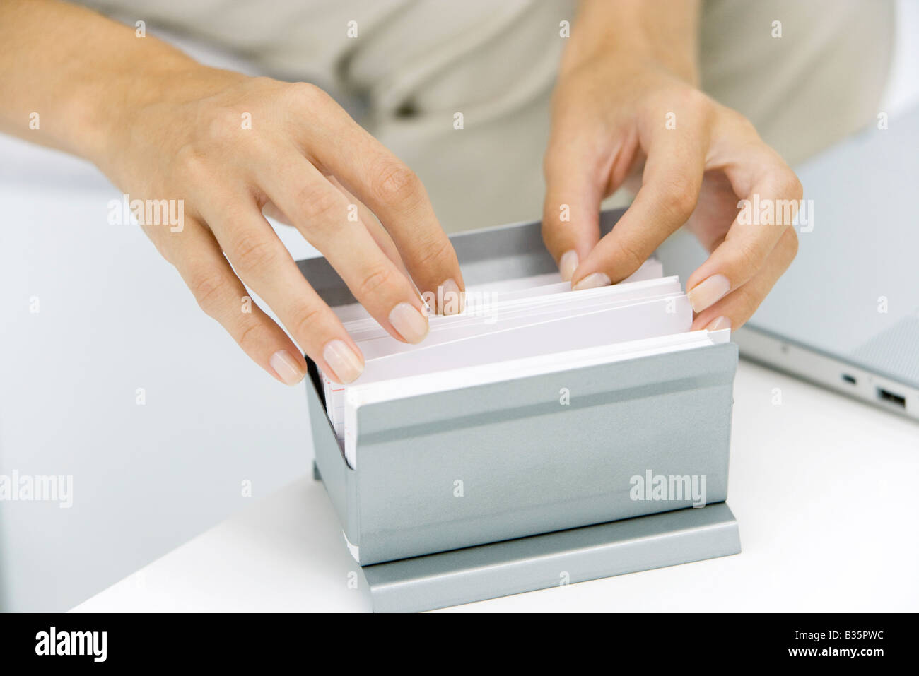 Hands flipping through card file, close-up Stock Photo - Alamy