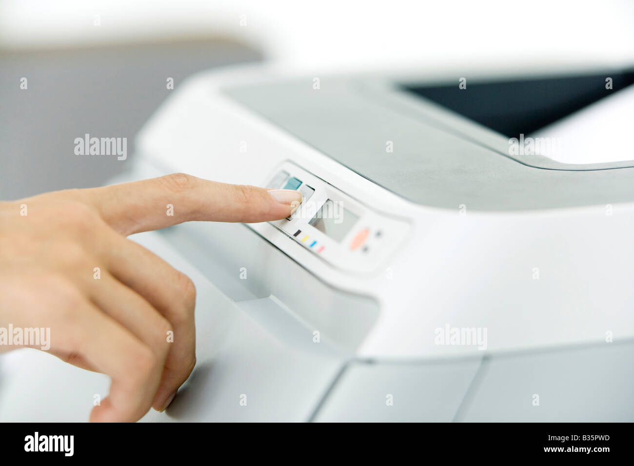 Hand pushing button on printer, close-up Stock Photo - Alamy