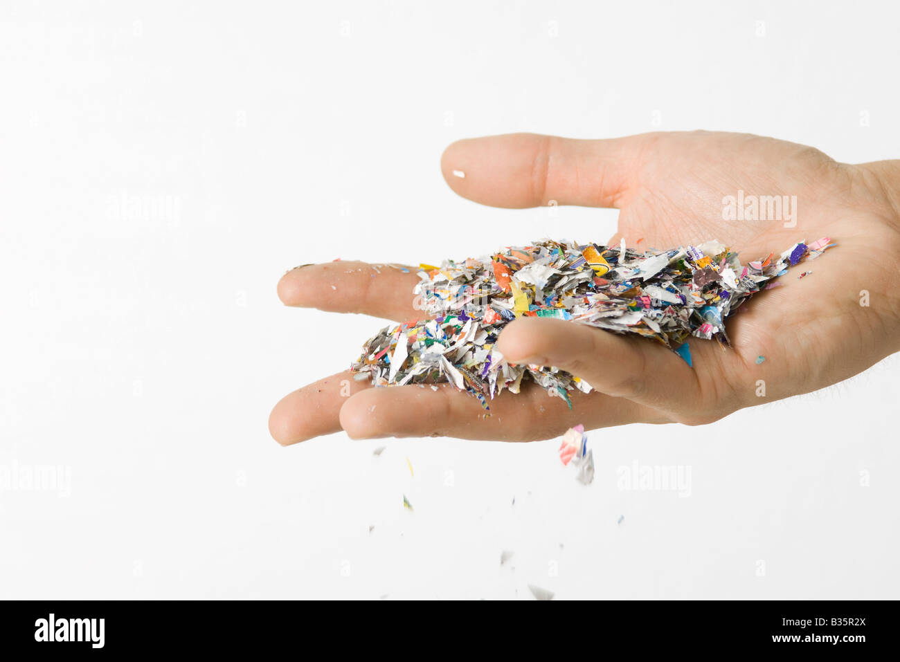 Hand holding confetti, cropped view Stock Photo - Alamy