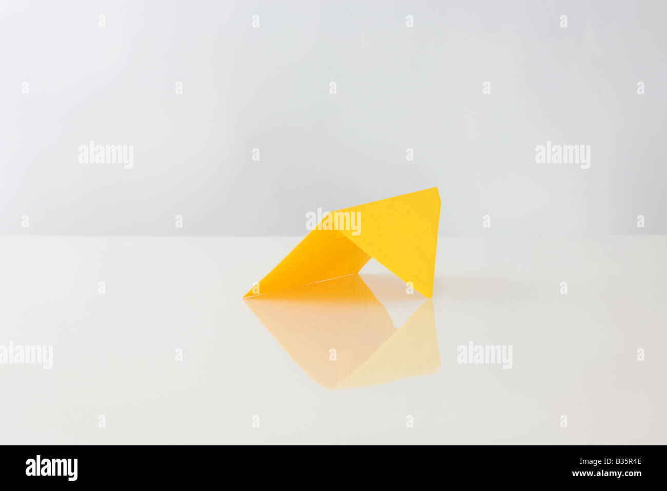 Yellow envelope propped up on table Stock Photo - Alamy