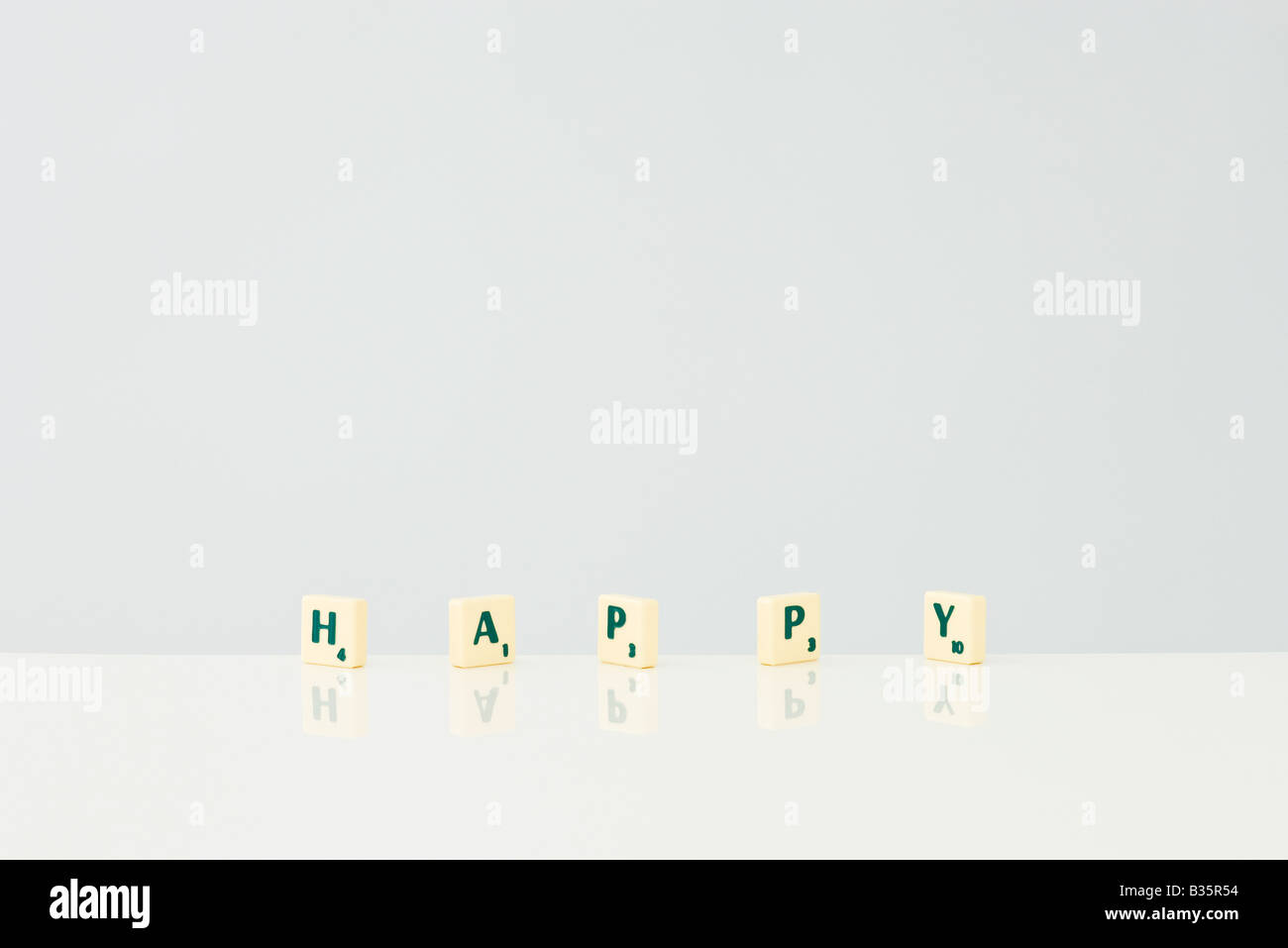 Word game tiles spelling the word "happy Stock Photo - Alamy