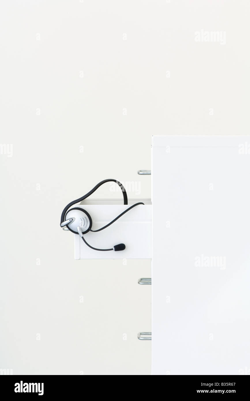 Headset hanging from open drawer of a filing cabinet, side view Stock ...