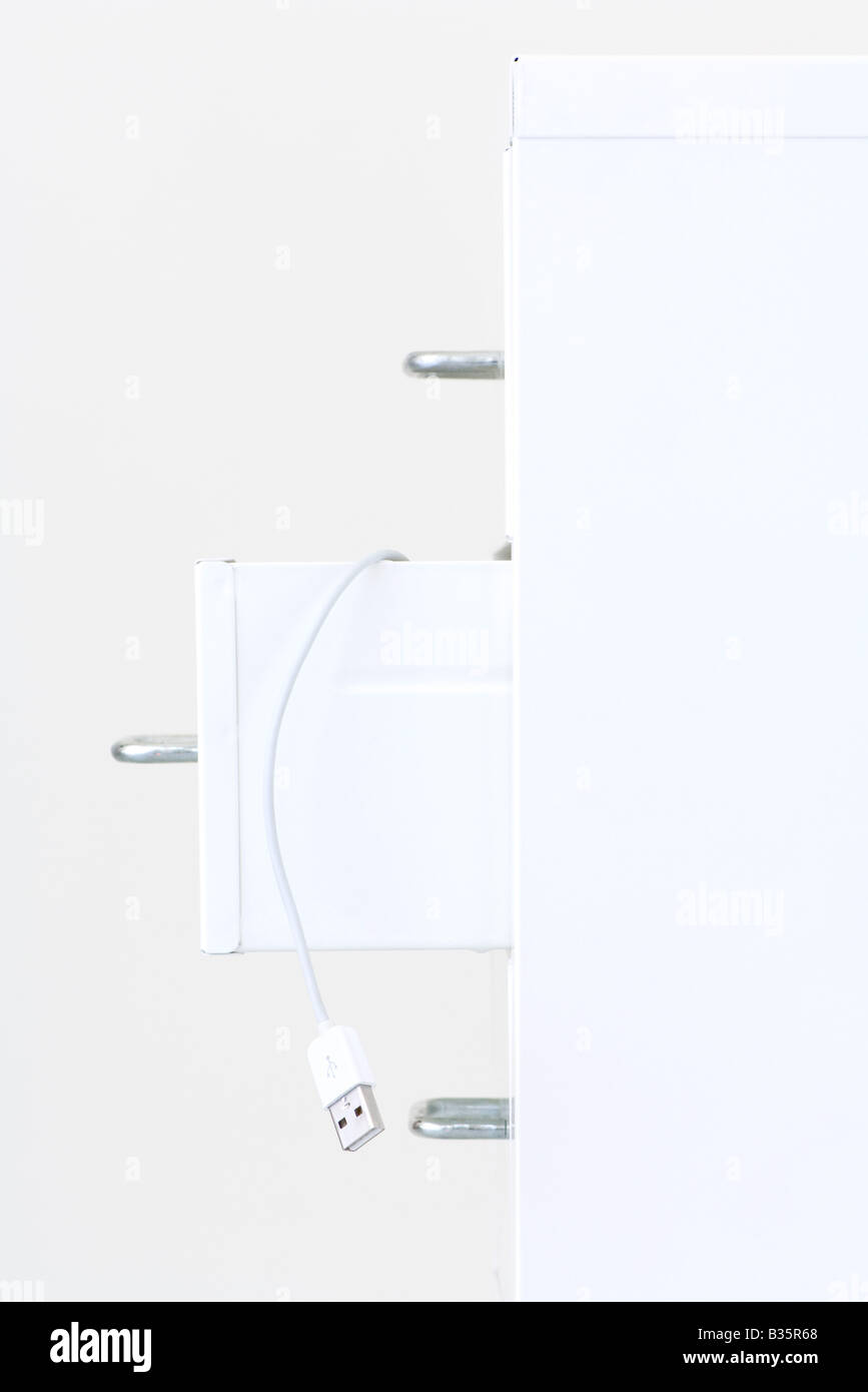USB cable hanging from open drawer of a filing cabinet, close-up Stock ...