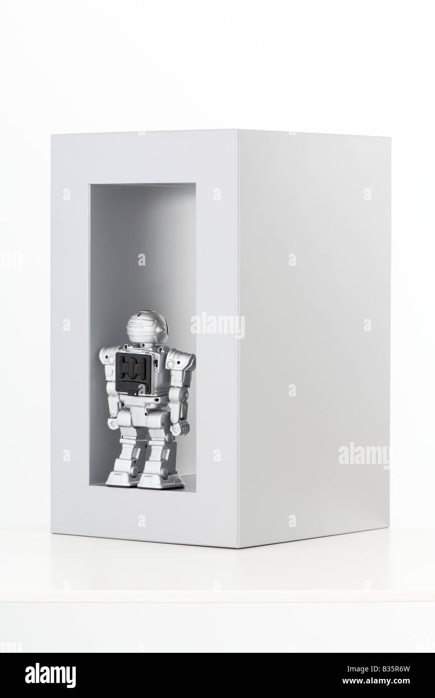 Toy robot standing inside of a block, rear view Stock Photo - Alamy