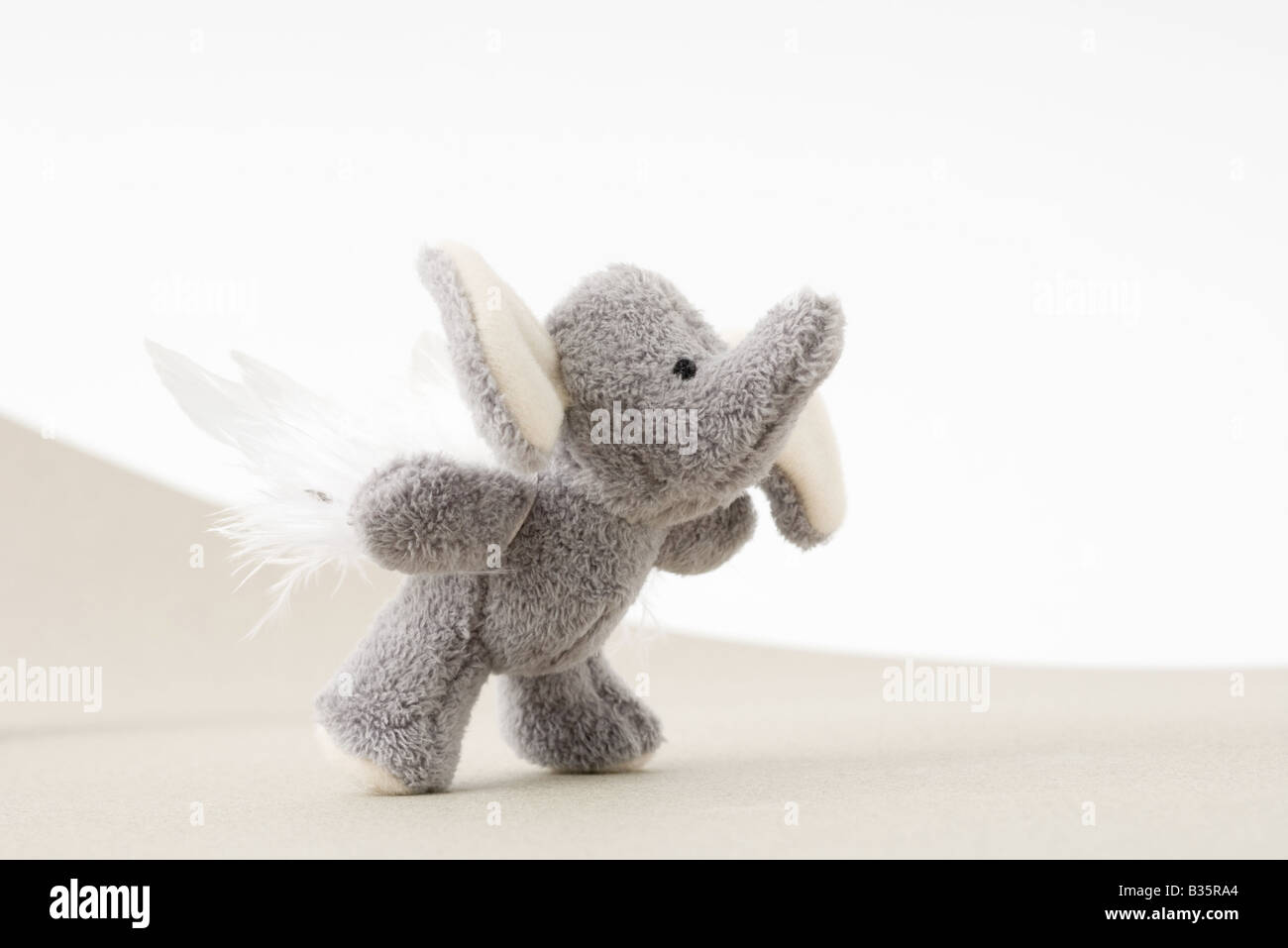 Stuffed elephant toy with wings trying to fly Stock Photo - Alamy