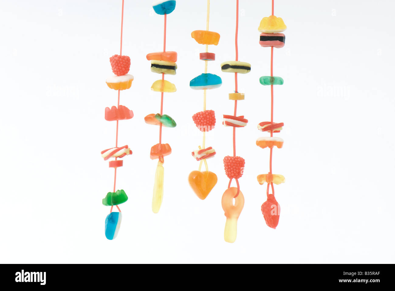 Strings of colorful candy Stock Photo - Alamy