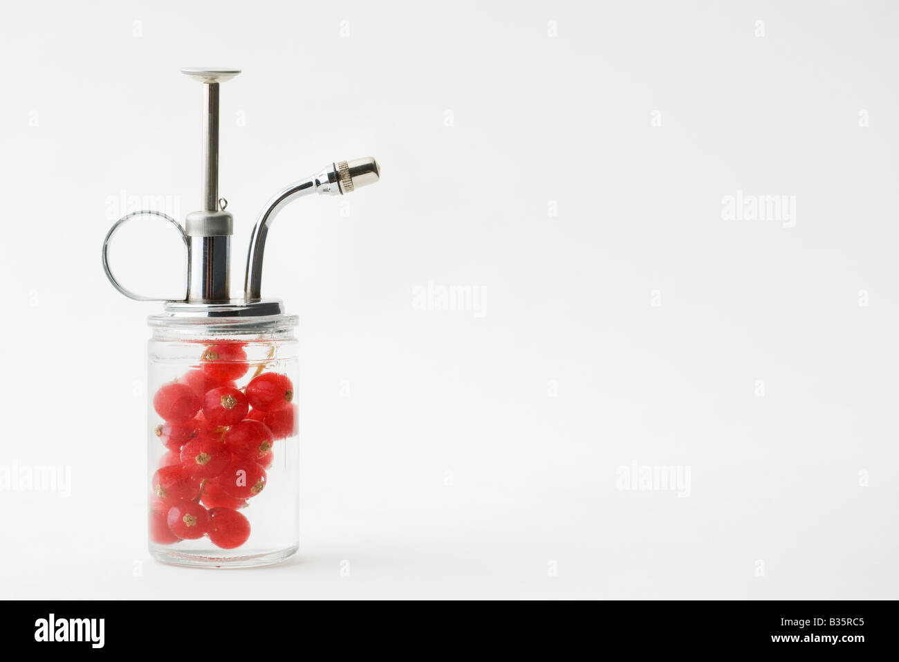 Spray bottle with red currants inside Stock Photo - Alamy