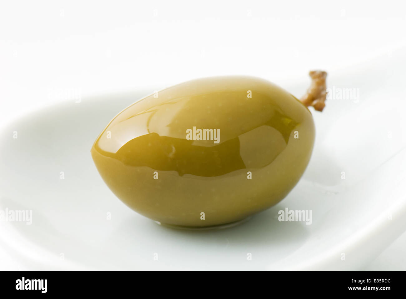 Green olive in small dish Stock Photo - Alamy