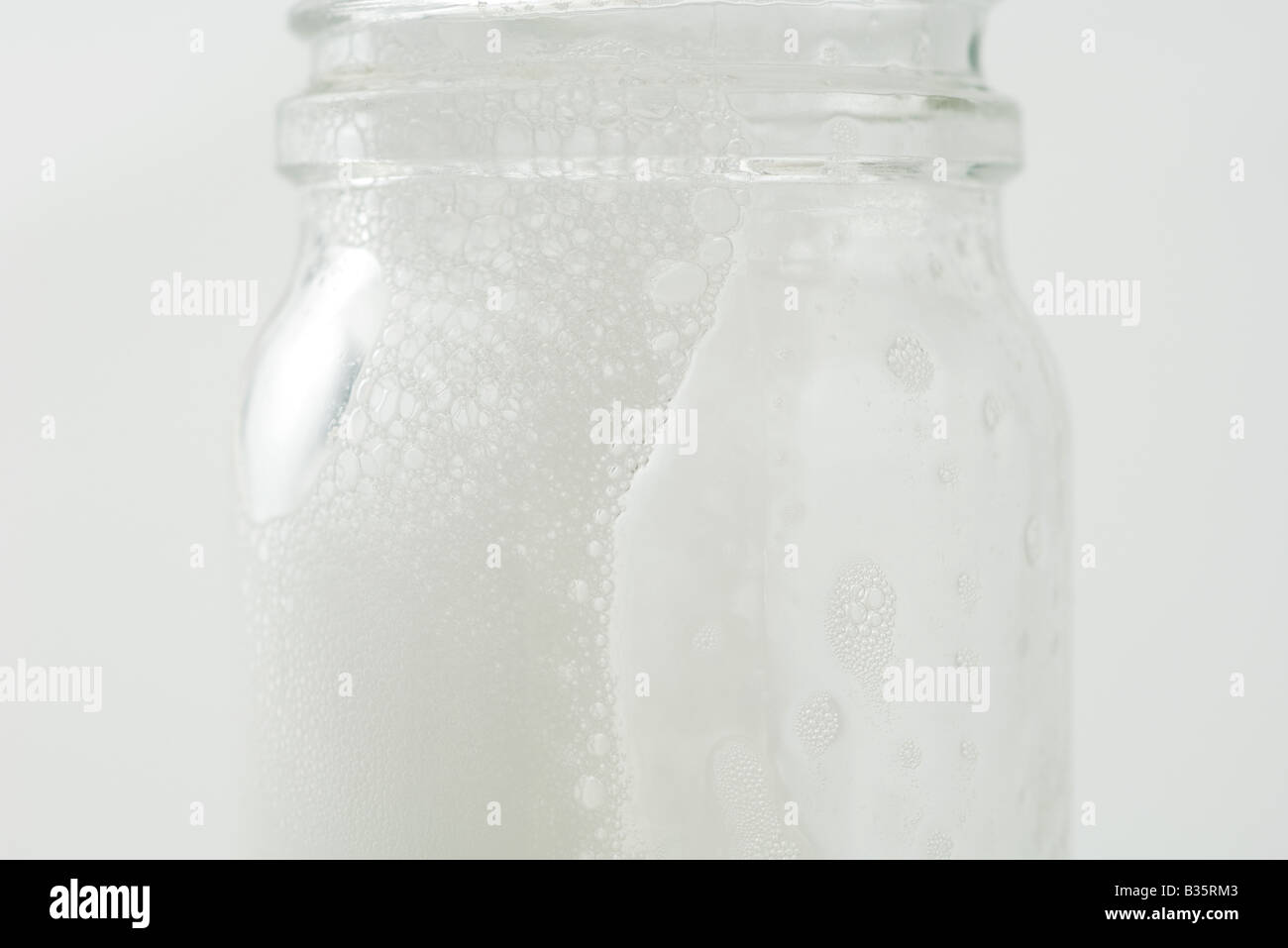 Glass jar with soap suds, close-up Stock Photo - Alamy