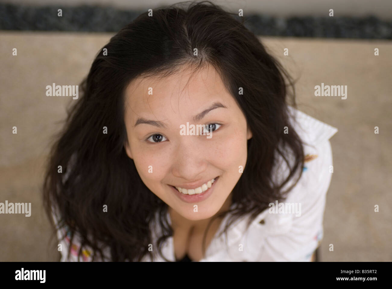 Young Asian woman looking up, high angle view Stock Photo - Alamy