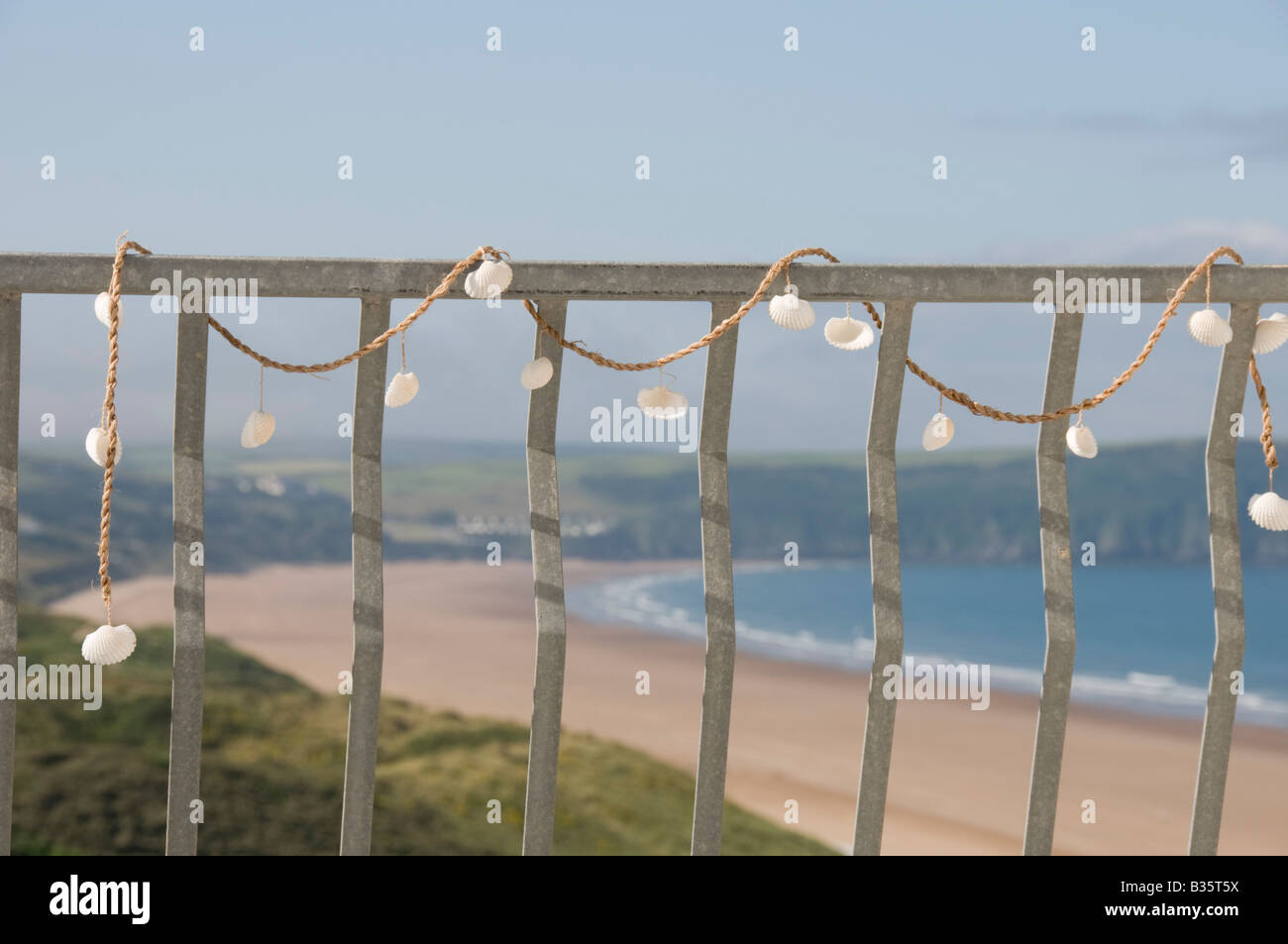A string of shells decorating a seaside balcony Stock Photo - Alamy