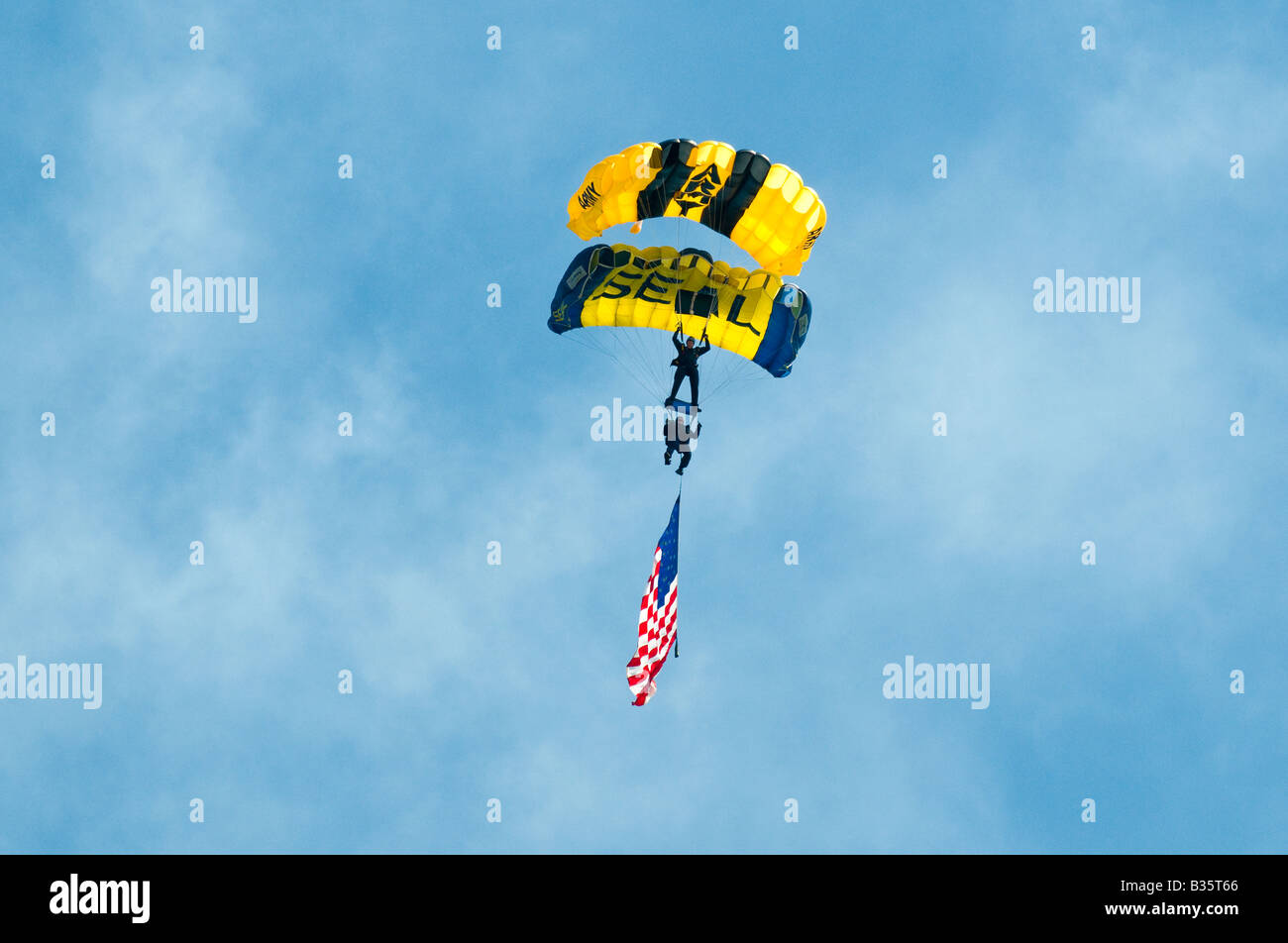 Two Skydivers atop each other, parachutes, & American Flag Stock Photo ...