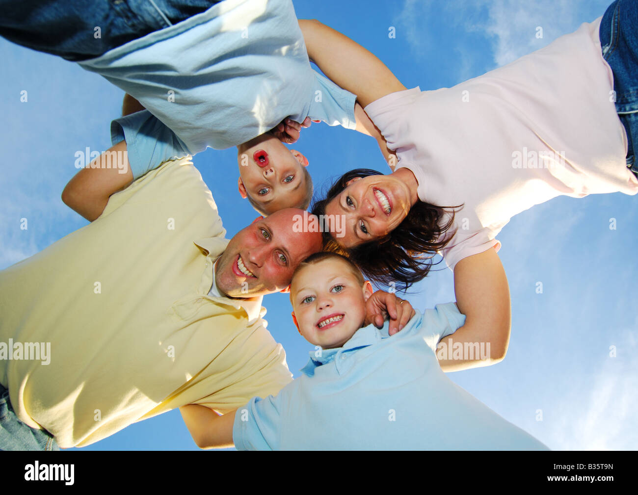 Low angle view of a family in a huddle Stock Photo - Alamy
