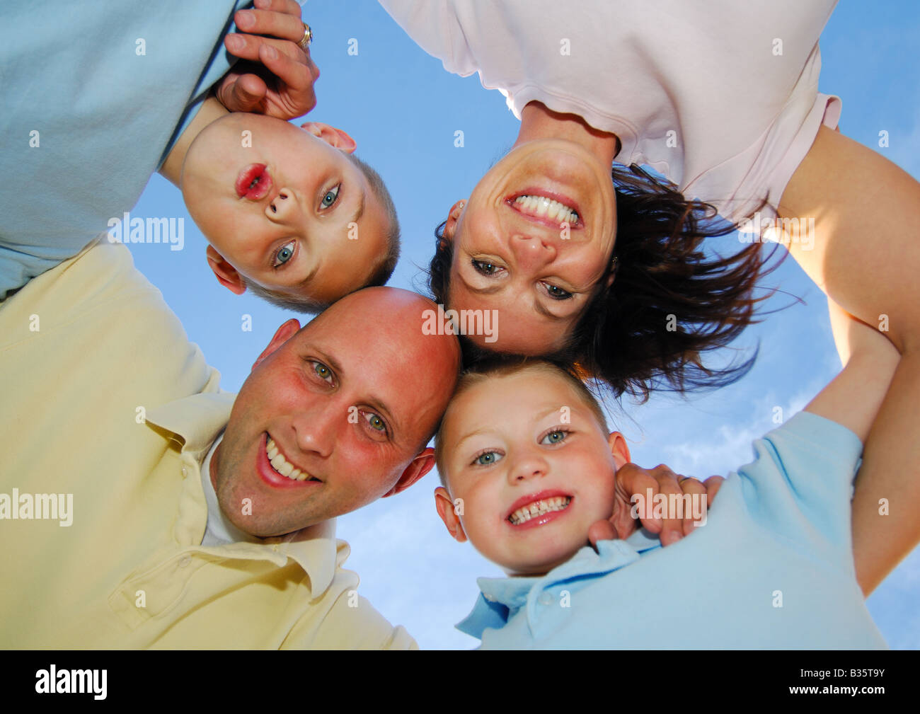 Low angle view of a family in a huddle Stock Photo - Alamy