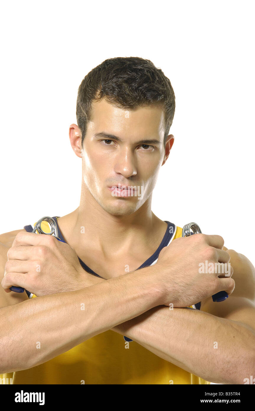 Portrait of a young man squeezing handgrips Stock Photo - Alamy