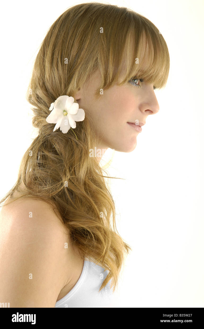 Side profile of a young woman wearing a flower in her hair Stock Photo ...