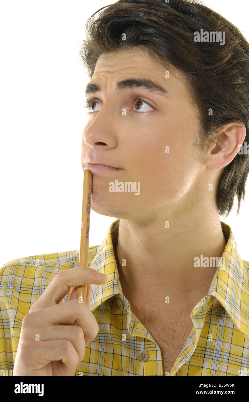 Close-up of a young man holding a pencil and thinking Stock Photo - Alamy