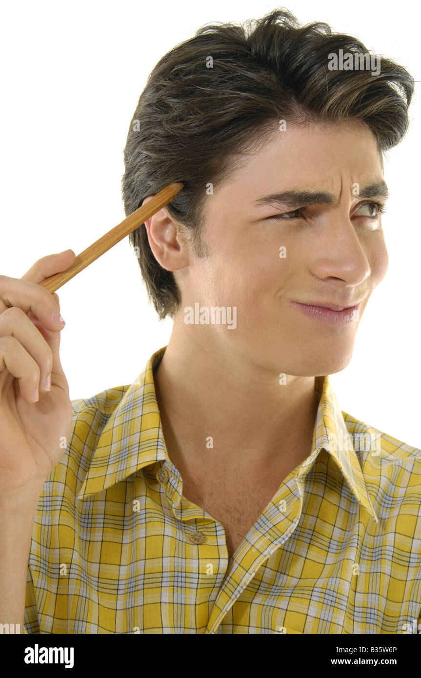 Close-up of a young man holding a pencil and making a face Stock Photo ...