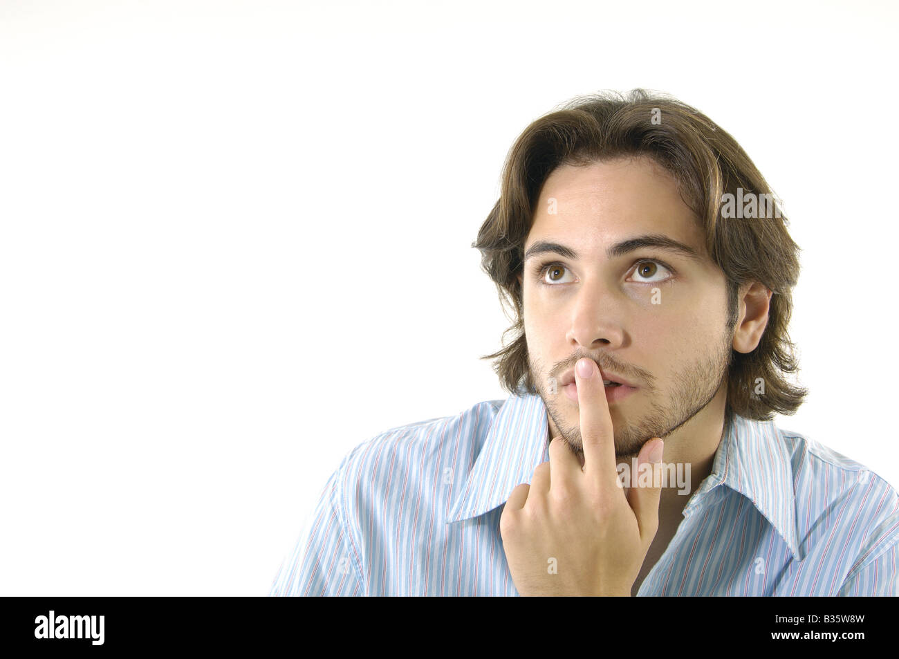Close-up of a young man thinking Stock Photo - Alamy