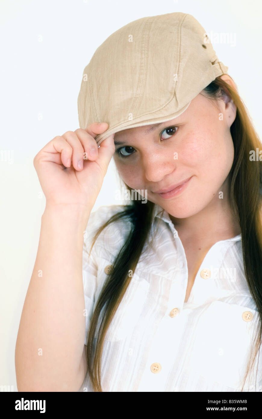 Young Asian woman tipping her cap portrait Stock Photo - Alamy