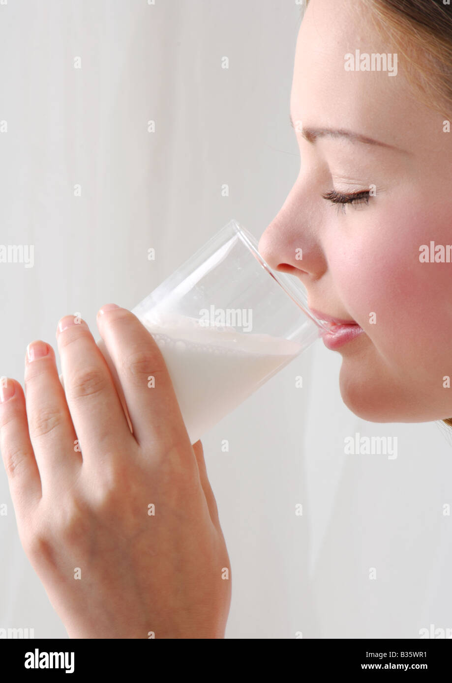 Side profile of a young woman drinking a glass of milk Stock Photo - Alamy