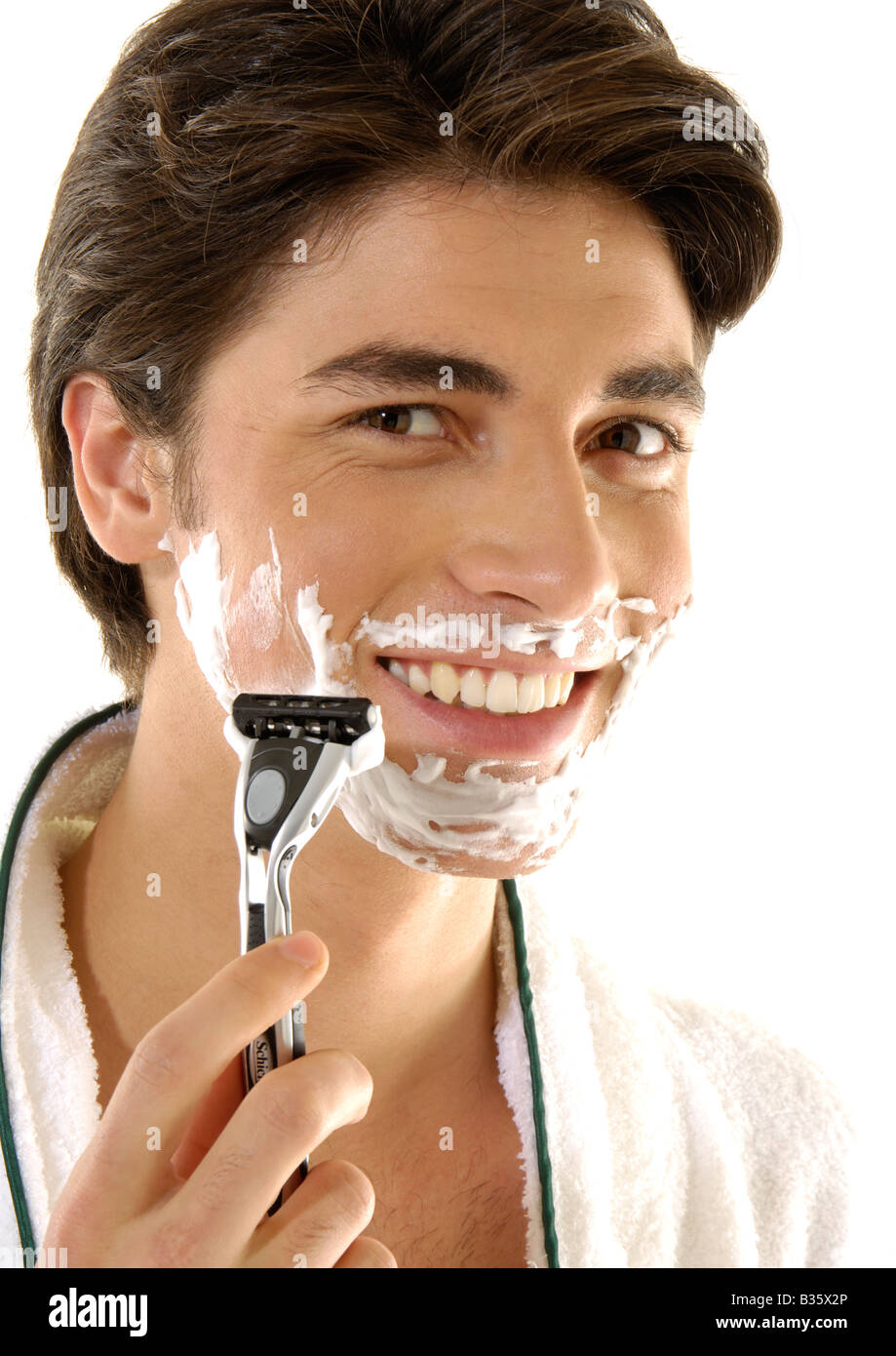Portrait of a young man shaving and smiling Stock Photo - Alamy