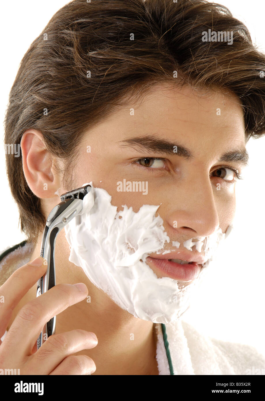 Portrait of a young man shaving Stock Photo - Alamy