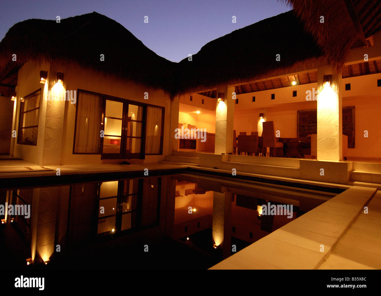 Swimming pool and a house lit up at night Stock Photo - Alamy