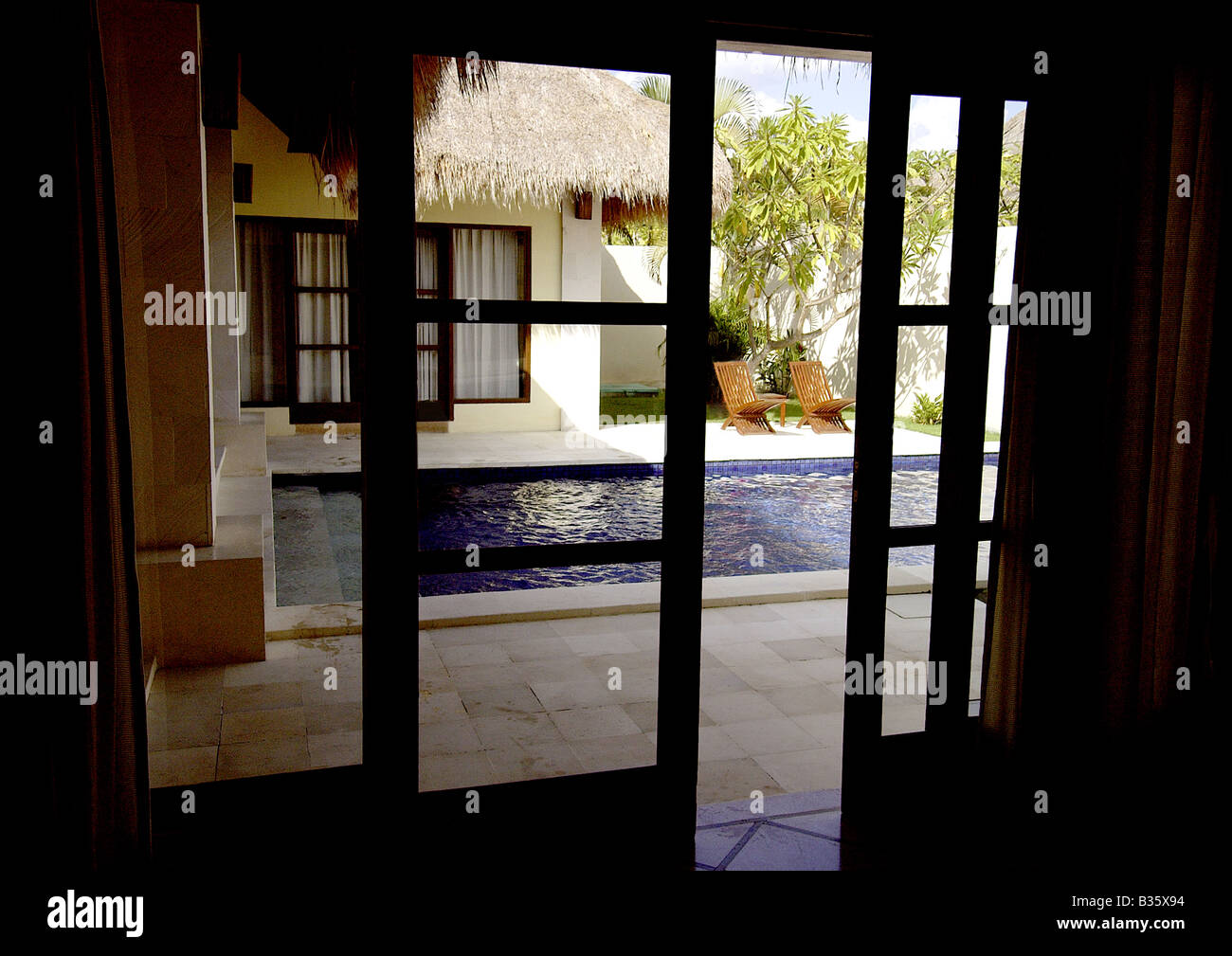 Swimming pool seen through a window Stock Photo - Alamy